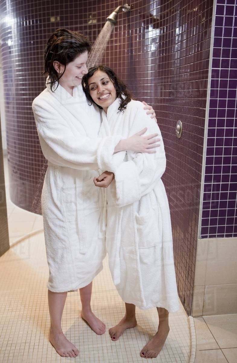 Women in bathrobes hugging in shower - Royalty-free Stock Photo | Dissolve