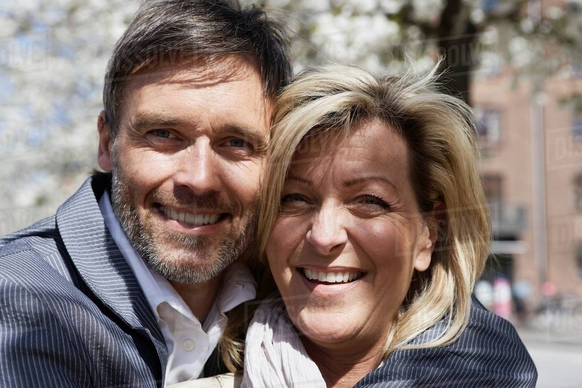 Close up of couples smiling faces - Stock Photo - Dissolve