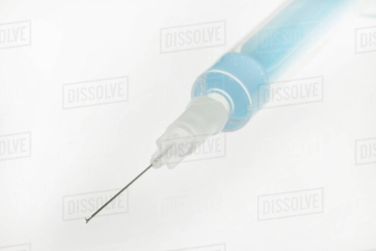 Close up of syringe needle - Stock Photo - Dissolve