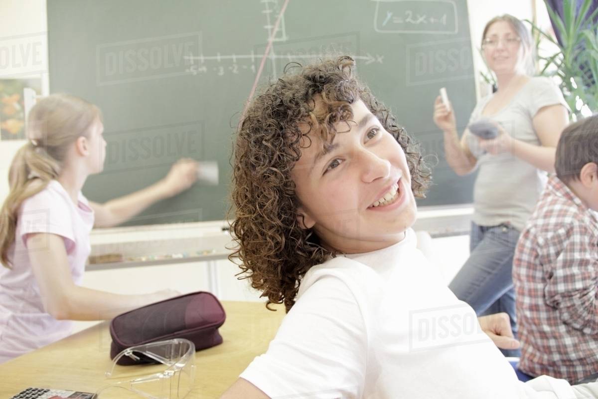 Student smiling in class - Royalty-free Stock Photo | Dissolve