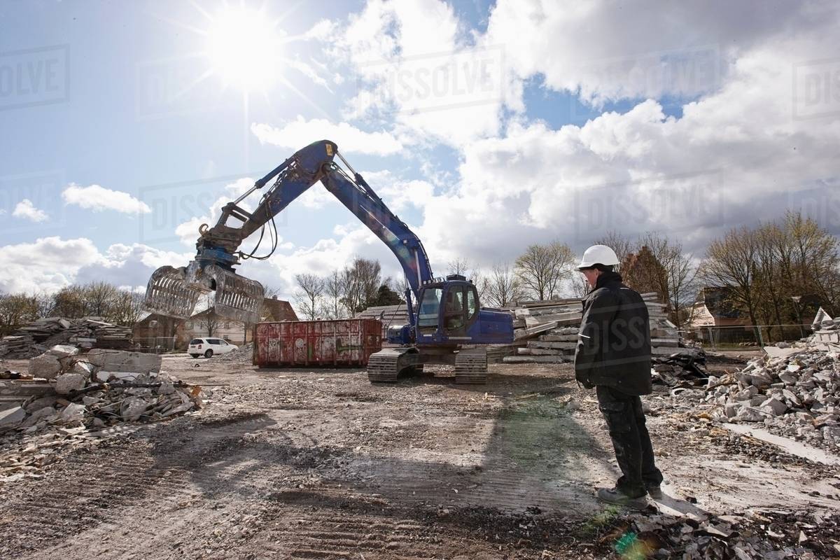 Worker standing on construction site - Stock Photo - Dissolve