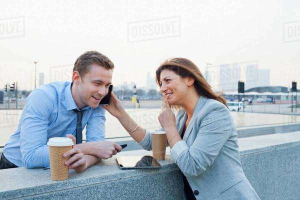 Business people talking on cell phone - Stock Photo - Dissolve