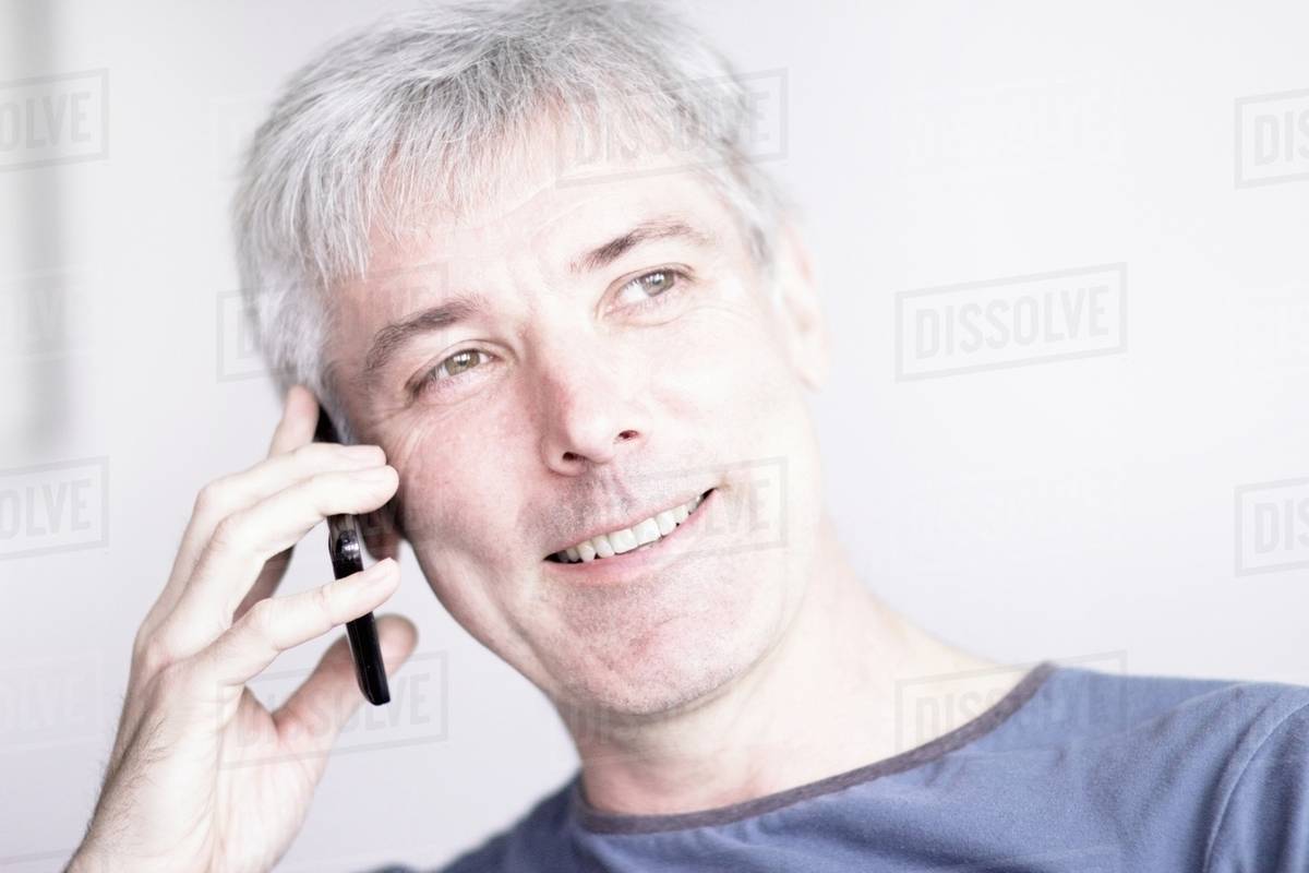 Smiling man talking on cell phone - Royalty-free Stock Photo | Dissolve