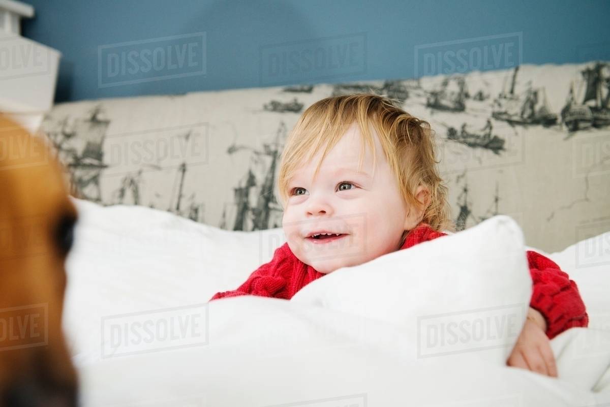 Boy smiling in bed - Royalty-free Stock Photo | Dissolve