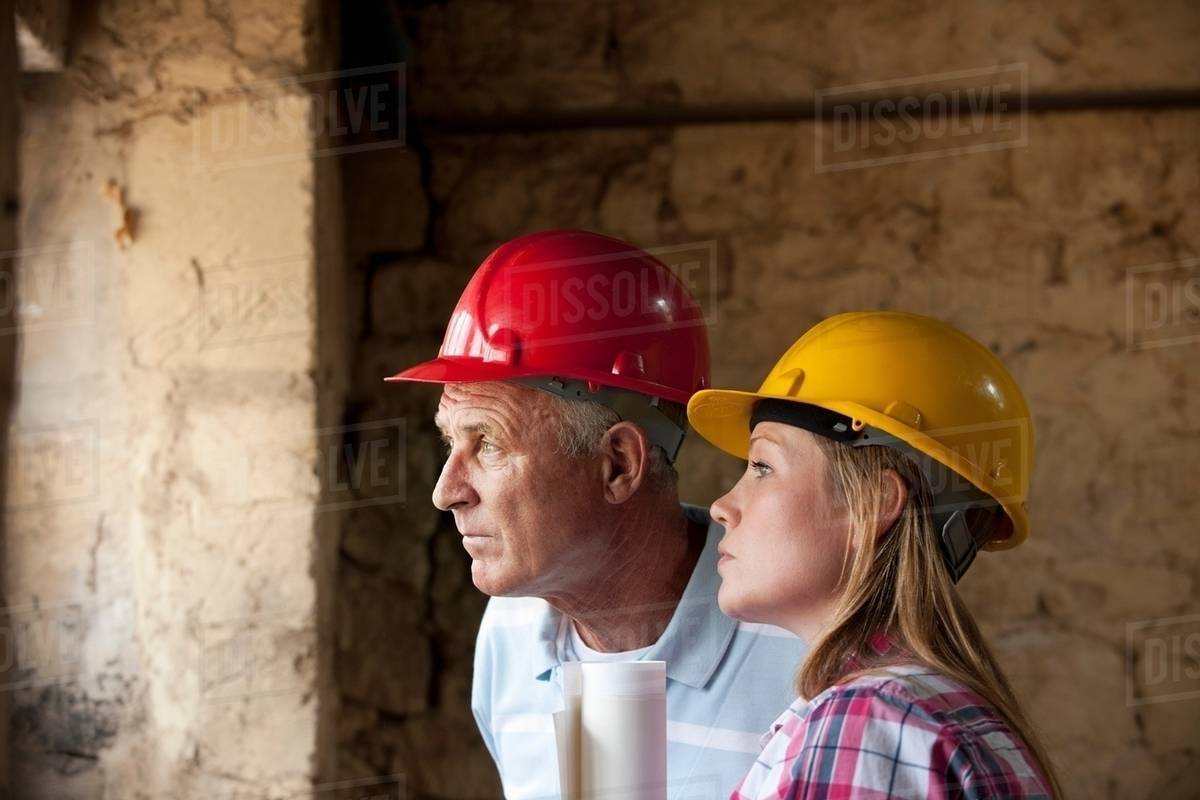 Construction workers standing on site - Stock Photo - Dissolve