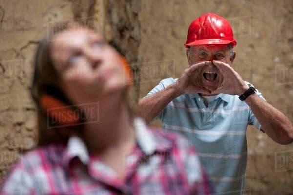 Construction worker yelling at colleague - Stock Photo - Dissolve