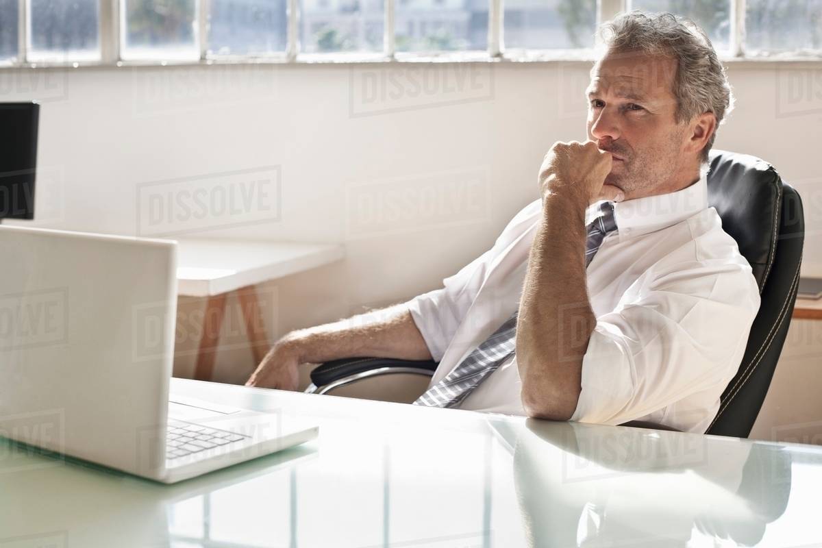 Businessman thinking at desk - Royalty-free Stock Photo | Dissolve