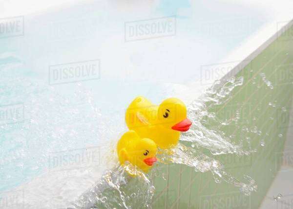 Rubber ducks falling out of bath overflowing with water - Royalty-free ...