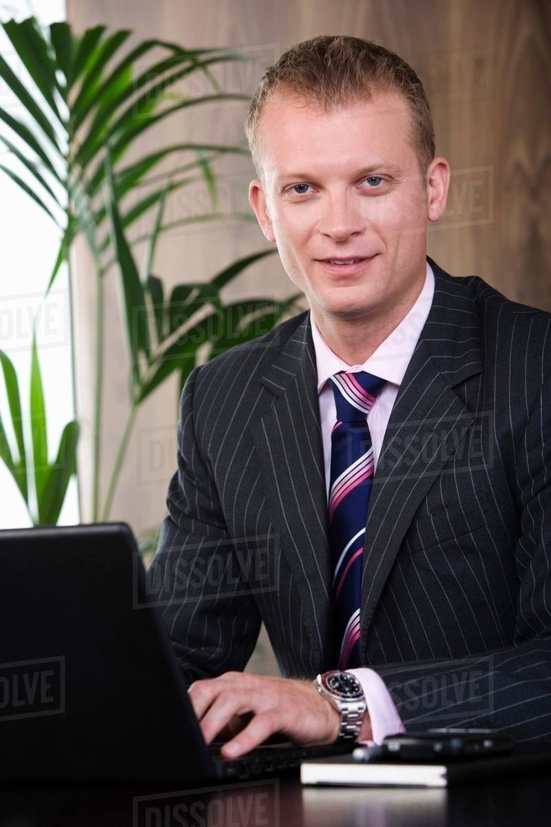 Business man at desk with computer - Royalty-free Stock Photo | Dissolve