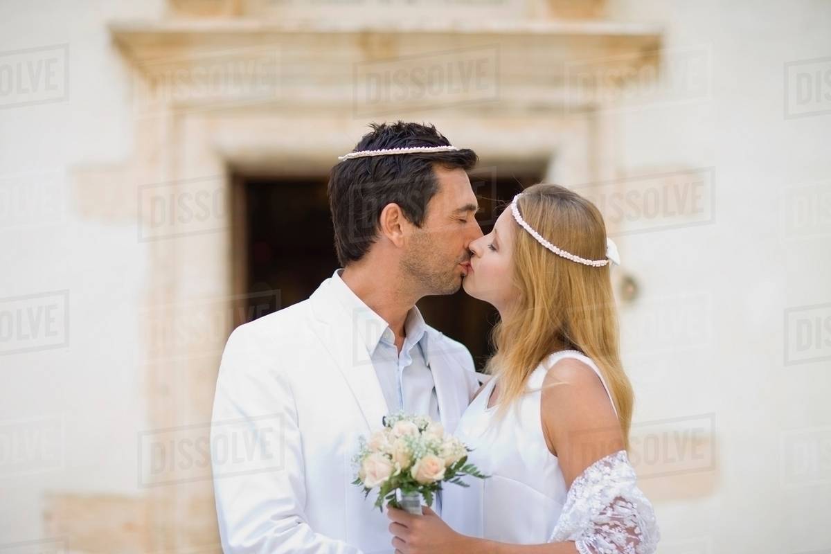 Kissing bridal couple - Stock Photo - Dissolve
