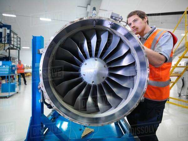 Engineer works on jet engine - Stock Photo - Dissolve