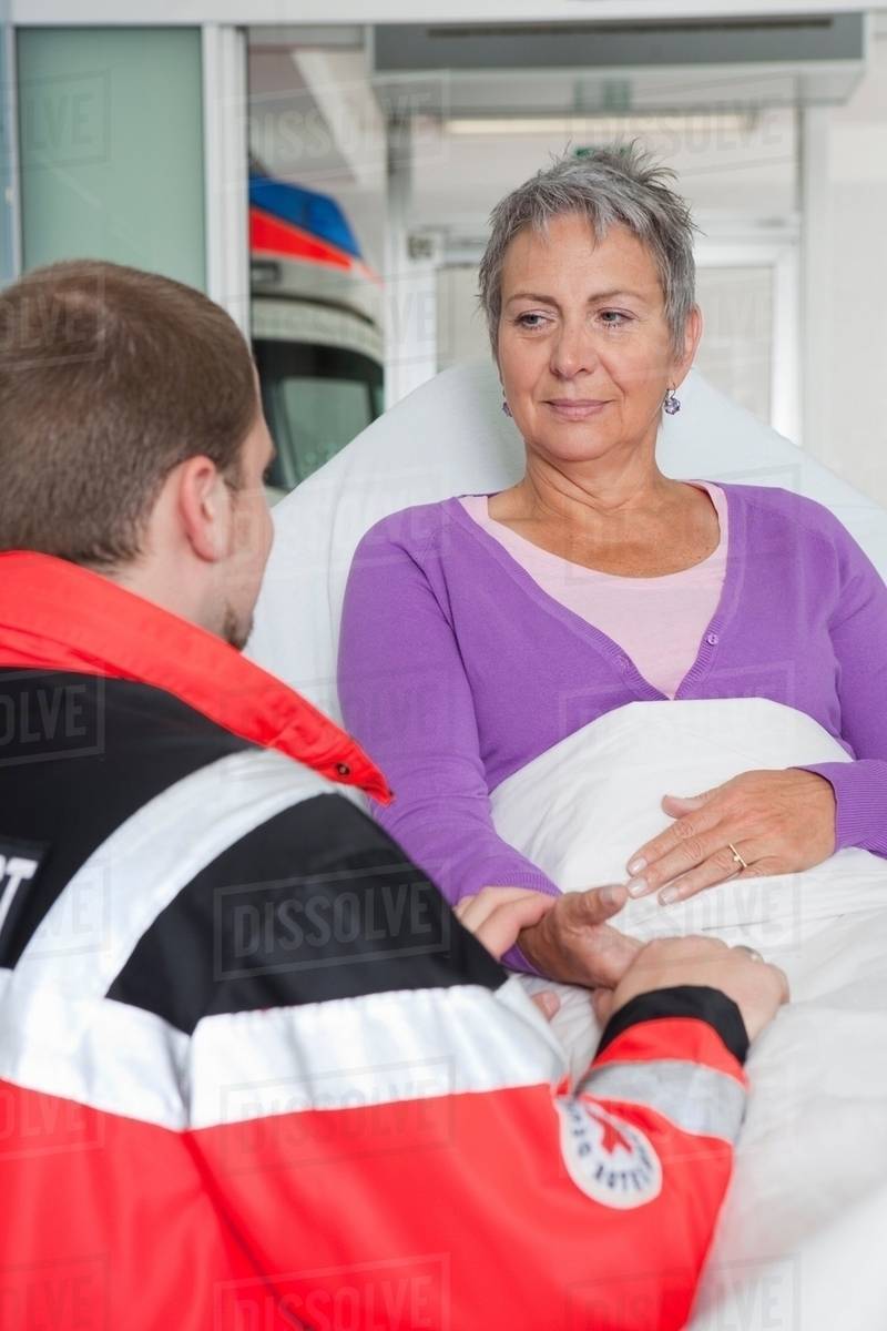 Paramedic caring about woman - Stock Photo - Dissolve