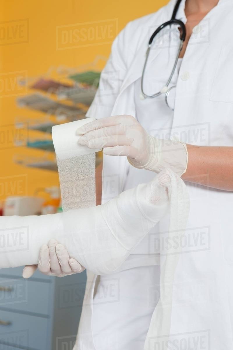 Close up of hands applying a dressing - Royalty-free Stock Photo | Dissolve