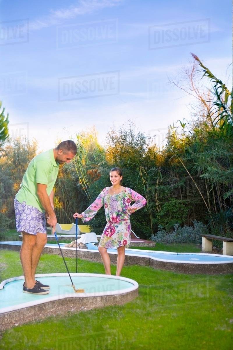 Couple play miniature golf - Royalty-free Stock Photo | Dissolve