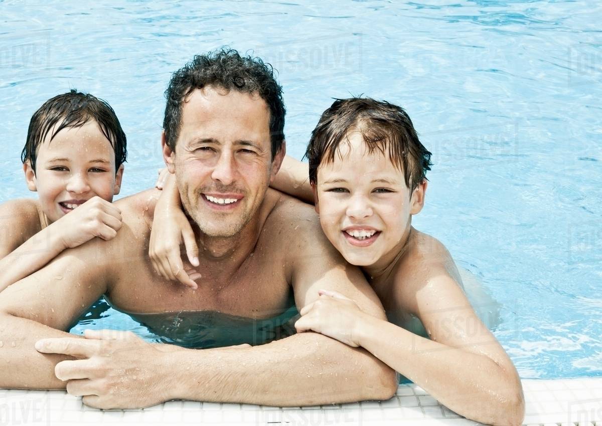 Father and 2 sons pool portrait - Stock Photo - Dissolve