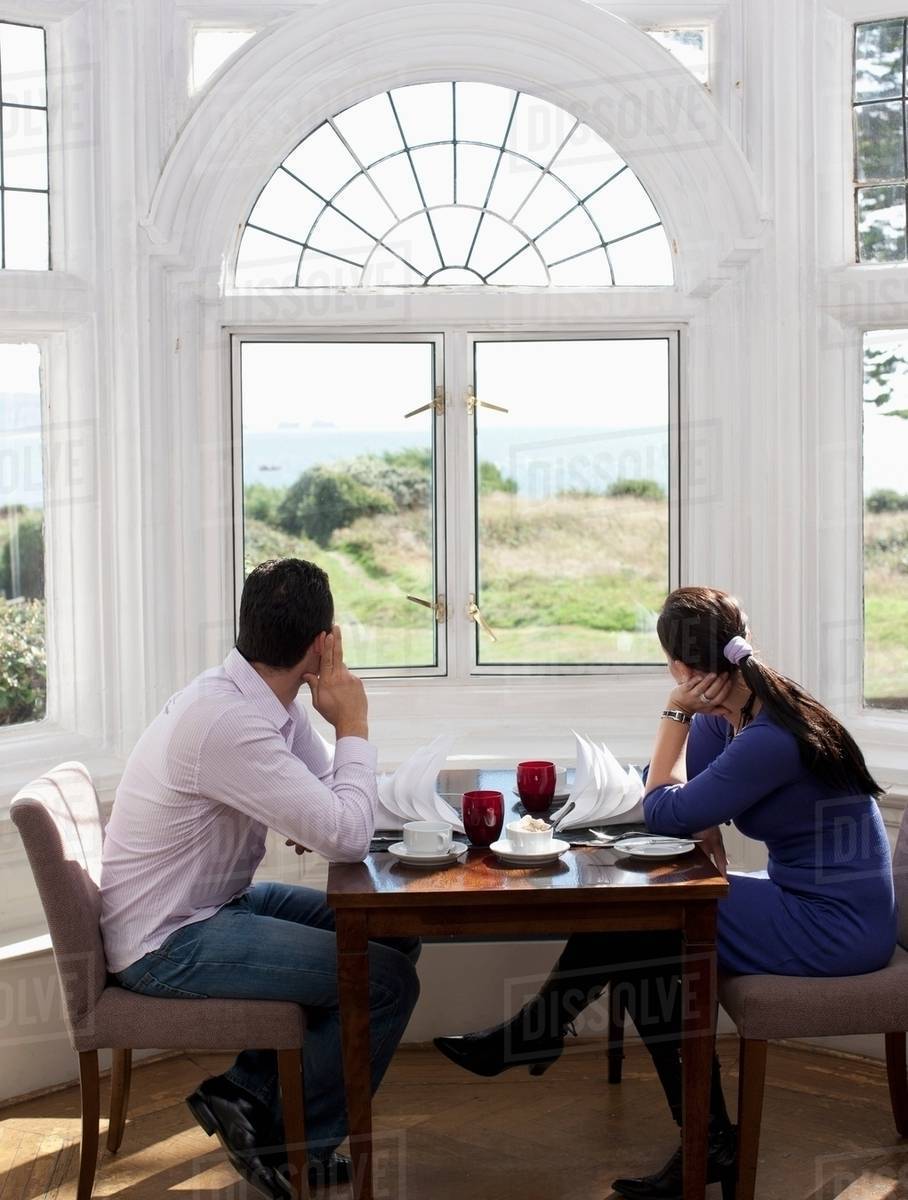 Couple looking out of the window - Stock Photo - Dissolve