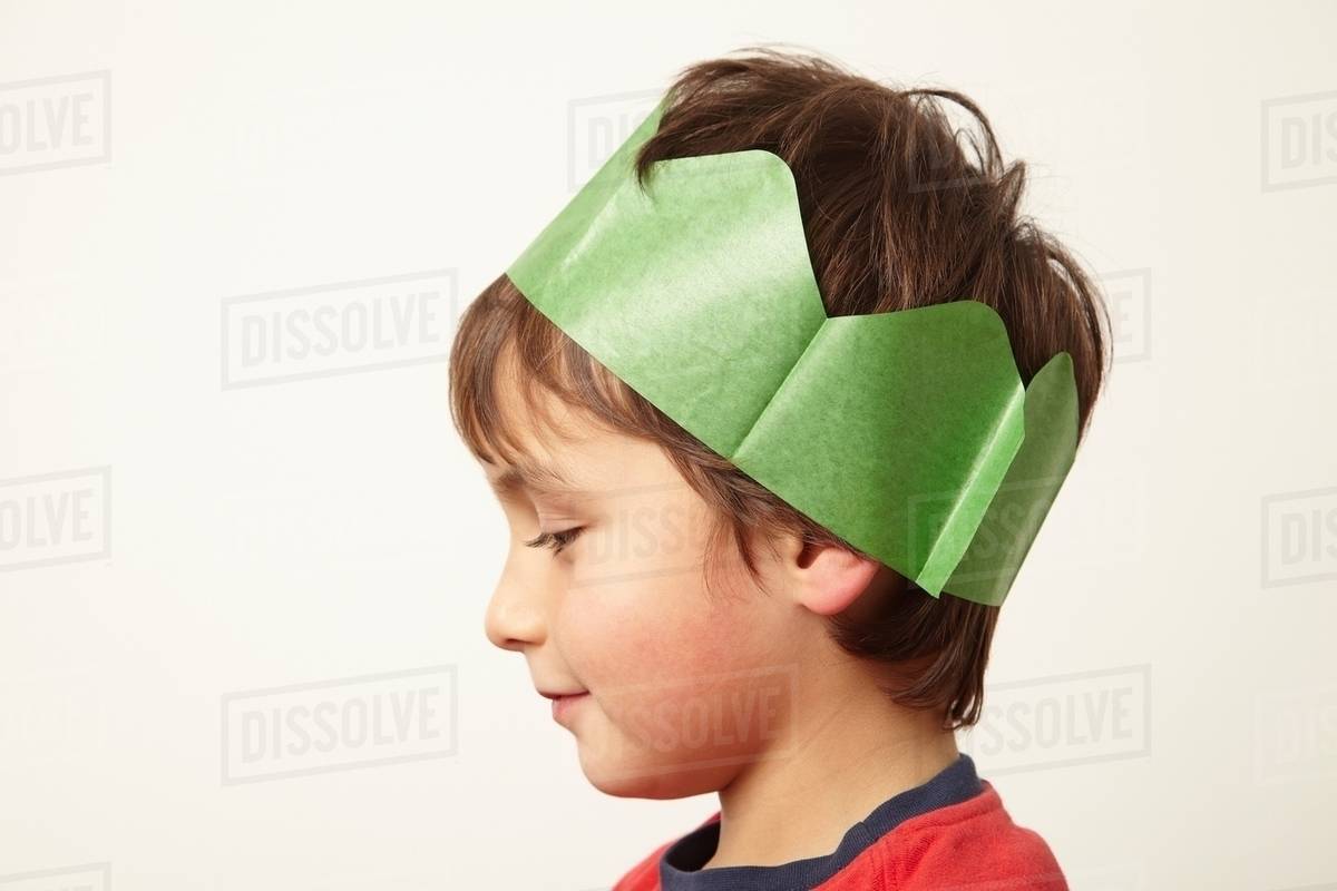 Boy wearing paper crown hat at Christmas - Stock Photo - Dissolve