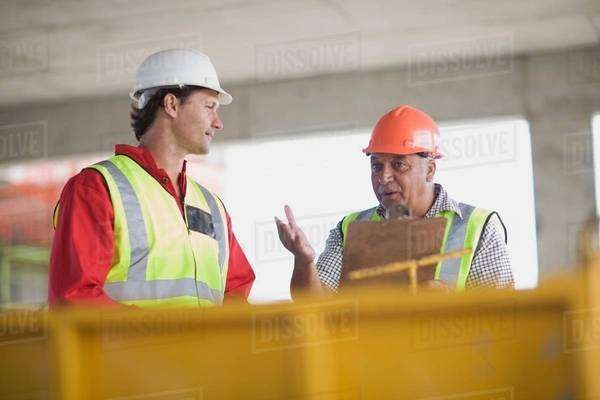 Architect talking to building worker - Royalty-free Stock Photo | Dissolve