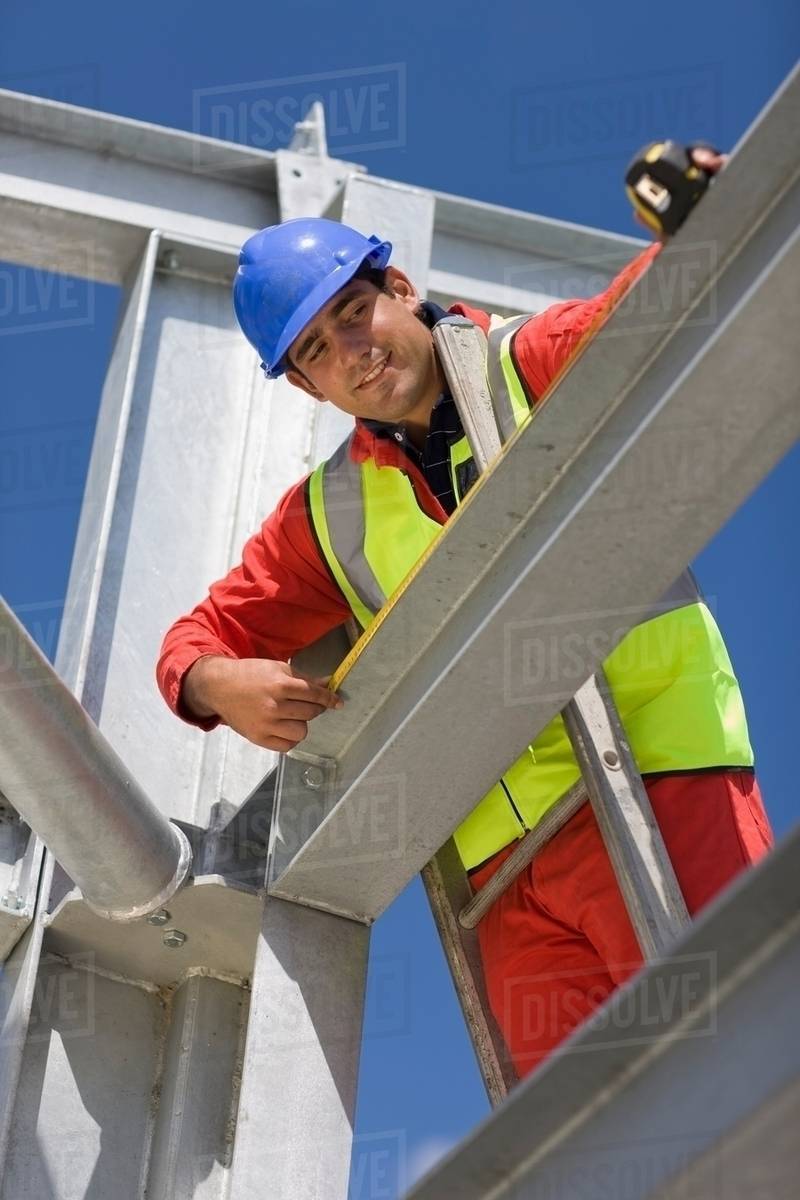 Worker standing on ladder - Royalty-free Stock Photo | Dissolve