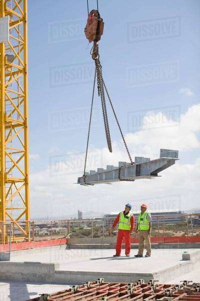 Crane and workers on construction site - Royalty-free Stock Photo ...