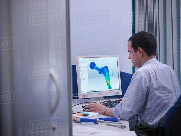 Worker with CAD drawing in office - Stock Photo - Dissolve