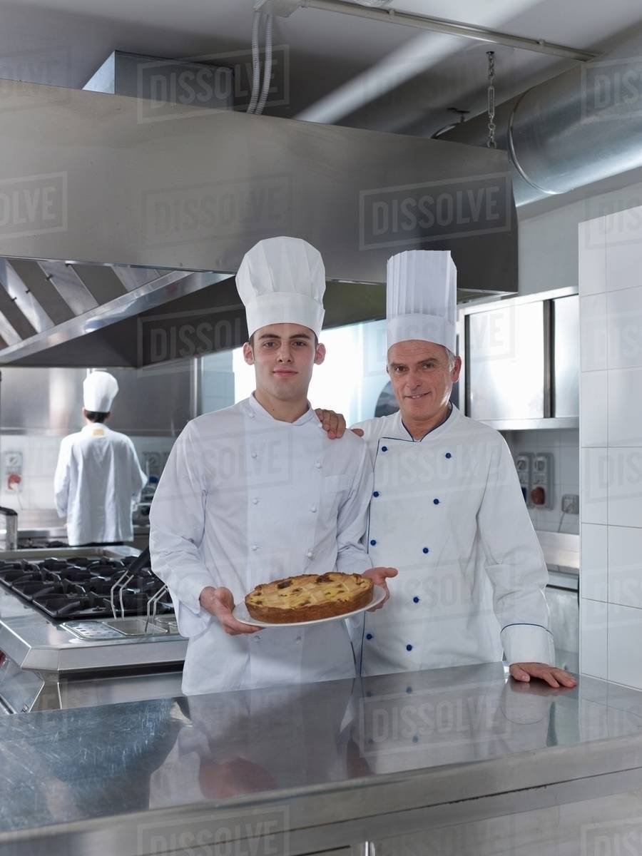 Chefs apprentice with home made cake - Stock Photo - Dissolve