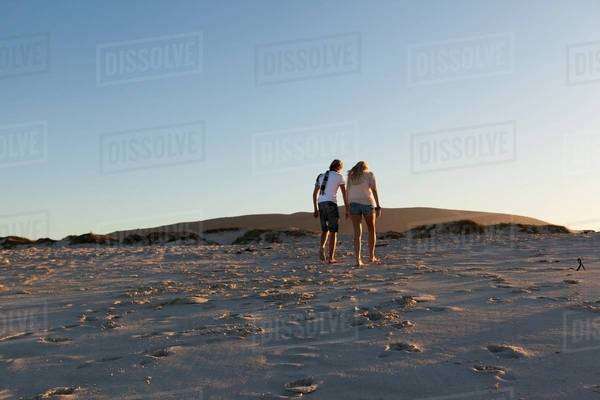 Boy and girl leaving beach - Royalty-free Stock Photo | Dissolve