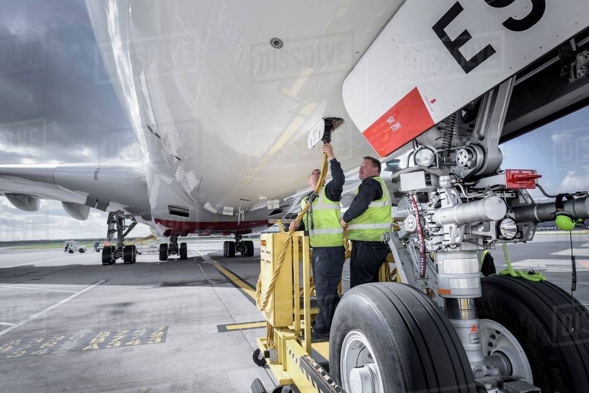 Ground crew operating loading equipment on A380 aircraft - Stock Photo ...