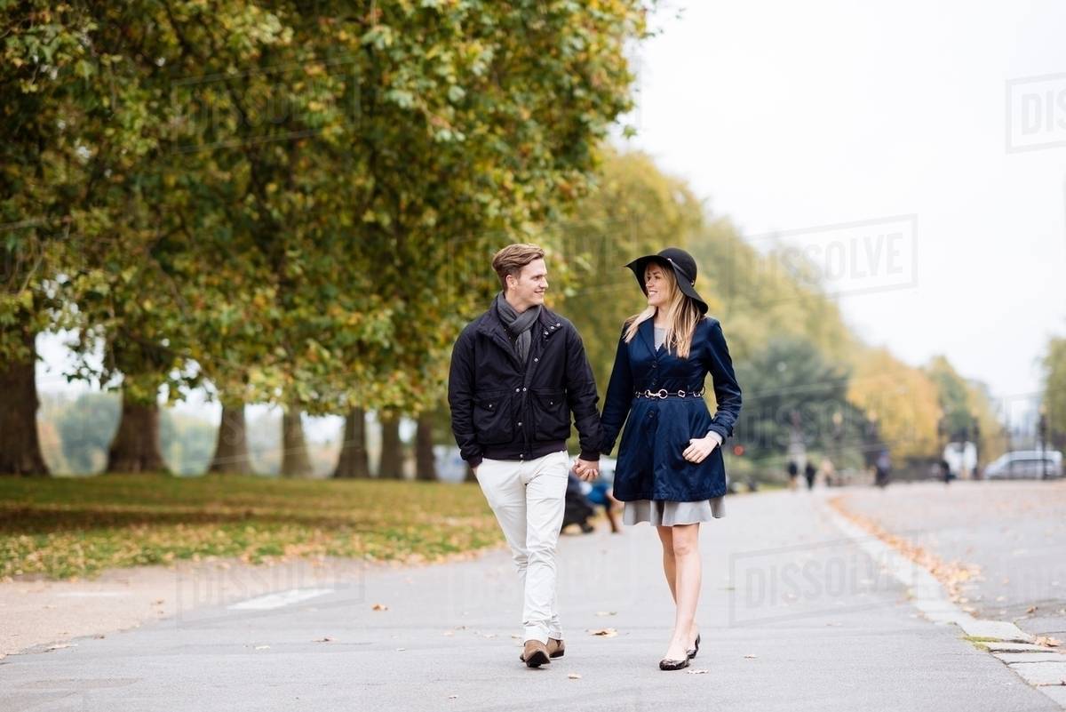 Romantic young couple strolling in park, London, England, UK - Stock ...