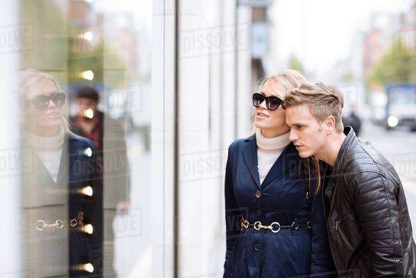 Young couple looking in shop window, London, England, UK - Stock Photo ...