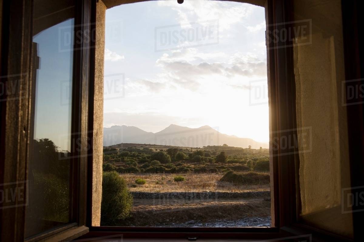 Open window view of rural landscape at dusk, Calvi, Corsica, France ...