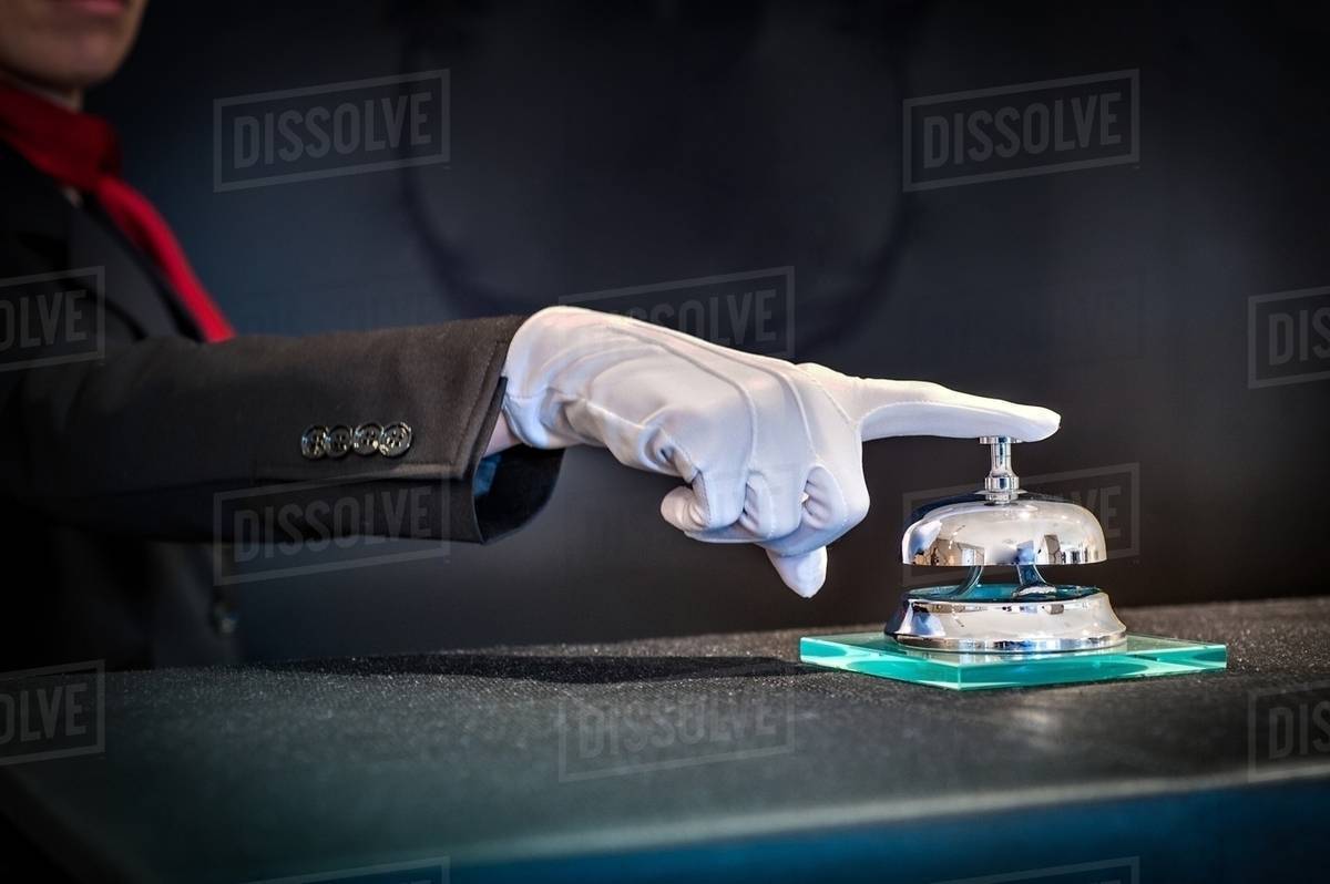 Concierge ringing reception bell - Royalty-free Stock Photo | Dissolve