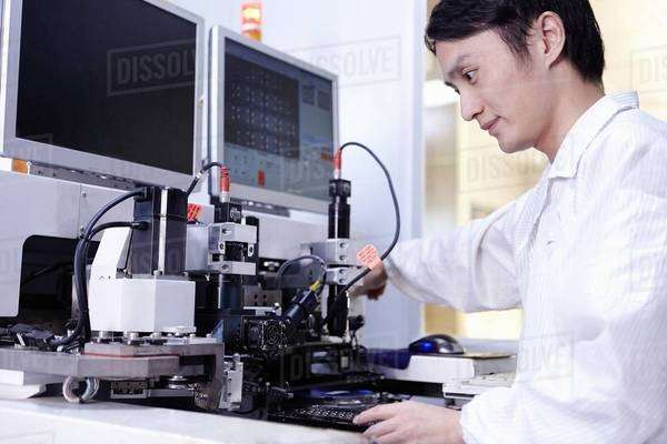 Technician working in LED factory - Stock Photo - Dissolve