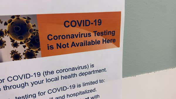 From interior hospital room, sign reads there is no testing for the ...