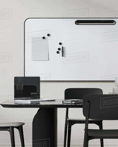 Office meeting room with long conference table and chairs, laptop and ...