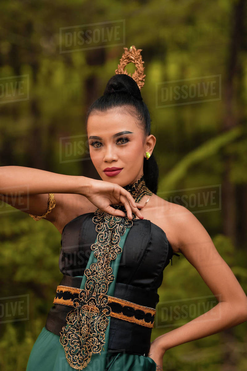 The fierce face of an Indonesian woman wearing makeup on her face and a ...