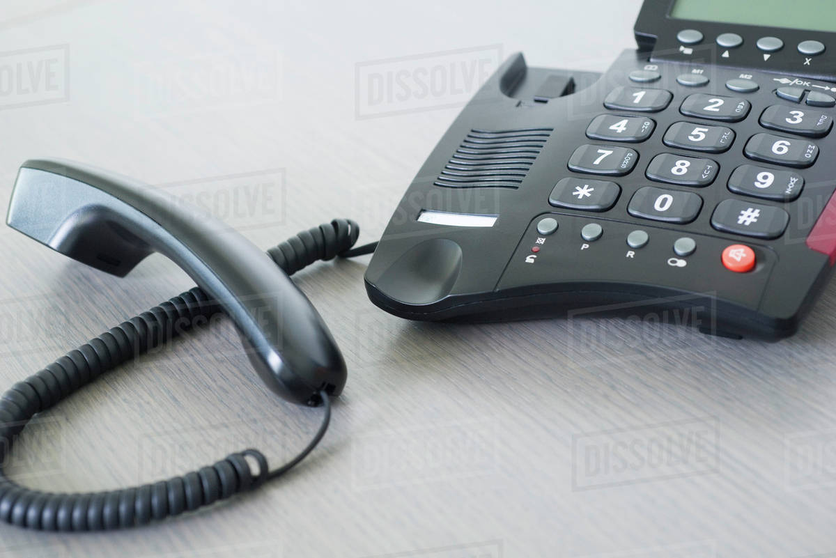 Receiver off landline phone - Stock Photo - Dissolve