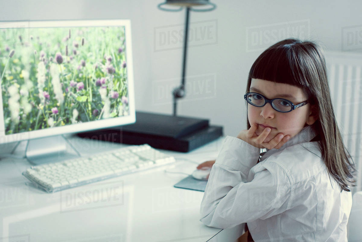 Girl sitting in front of desktop computer - Royalty-free Stock Photo ...