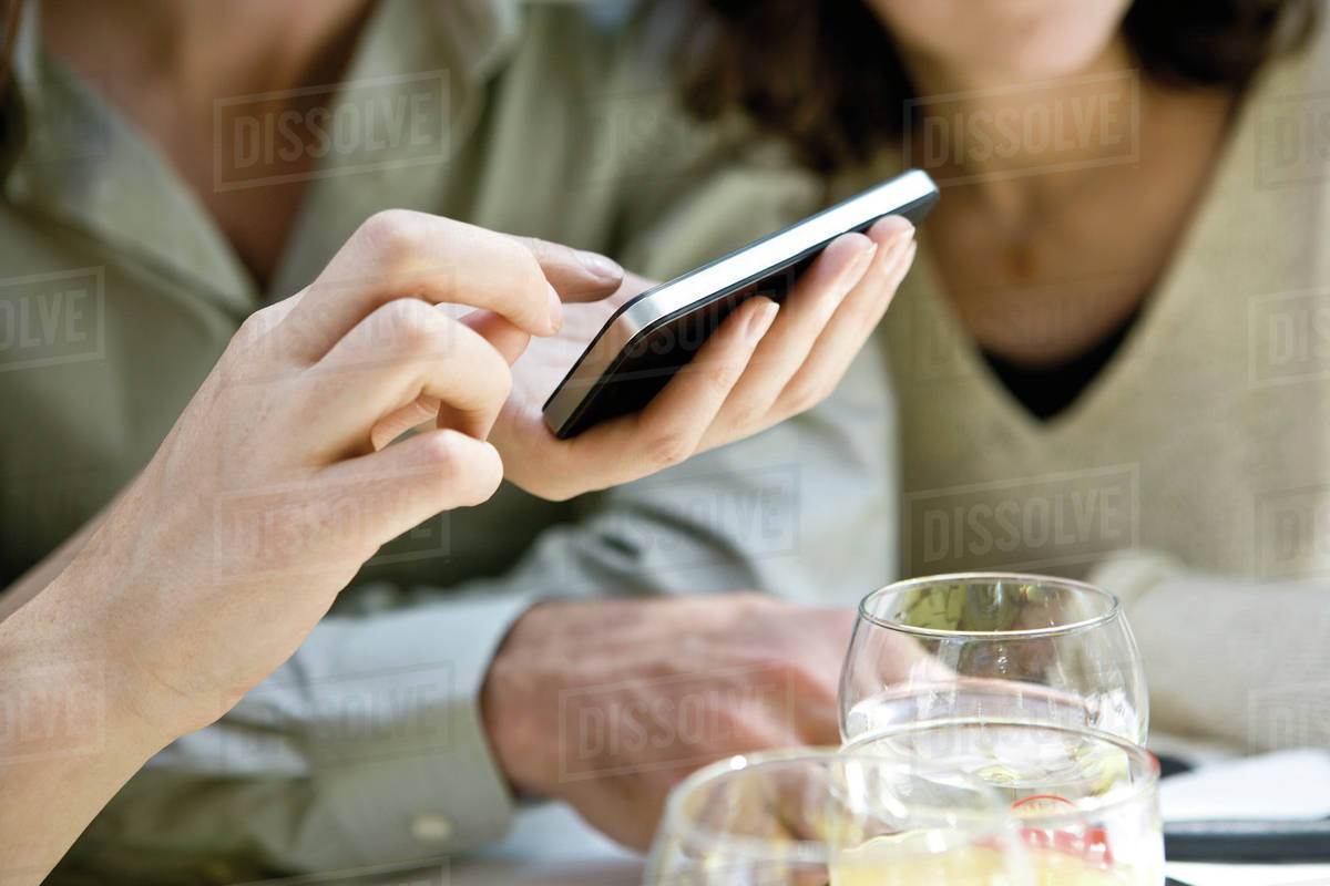 Person using cell phone, cropped - Royalty-free Stock Photo | Dissolve