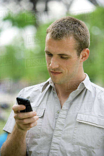 Man text messaging with cell phone - Royalty-free Stock Photo | Dissolve