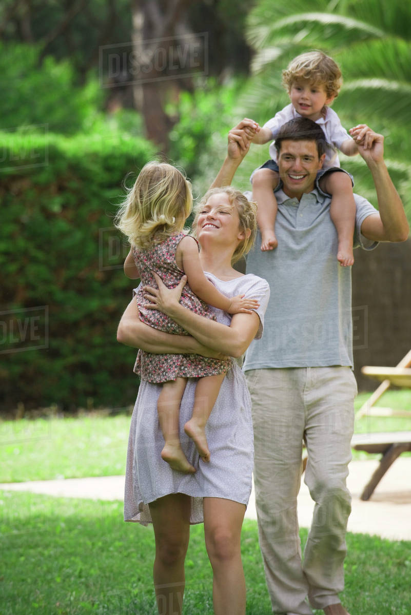 Parents carrying children outdoors - Royalty-free Stock Photo | Dissolve