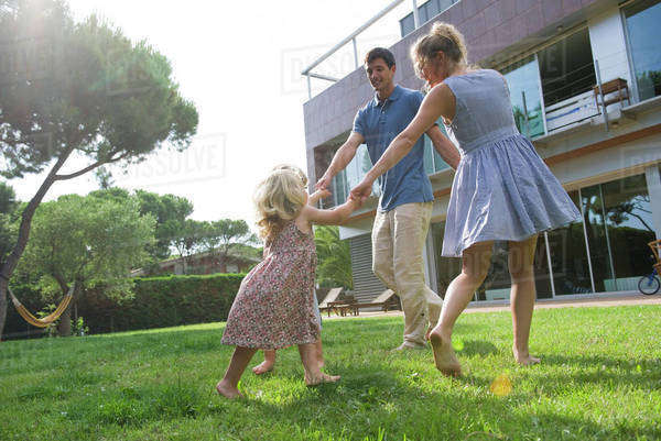 Family playing ring-around-the-rosy outdoors - Royalty-free Stock Photo ...