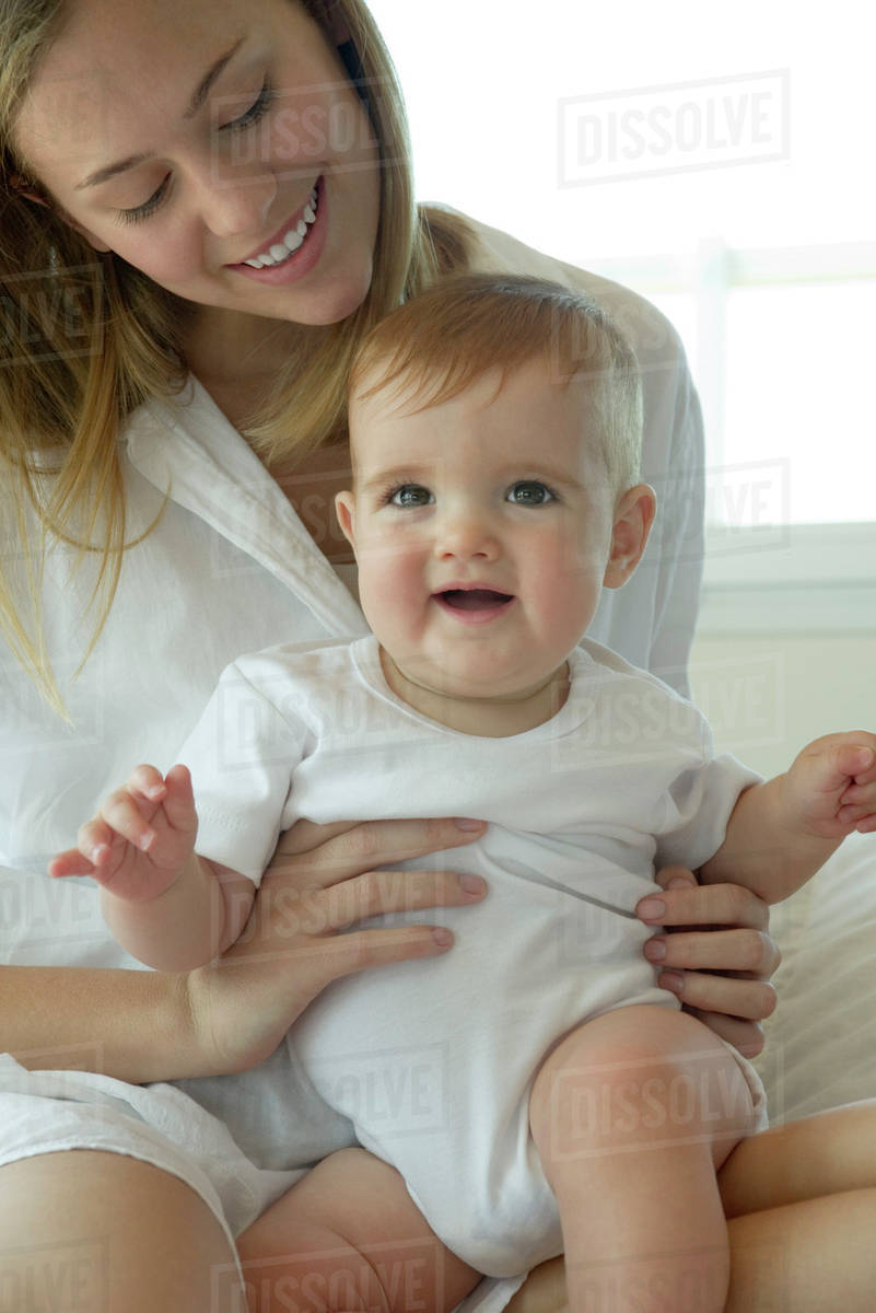 Mother holding baby on lap - Stock Photo - Dissolve