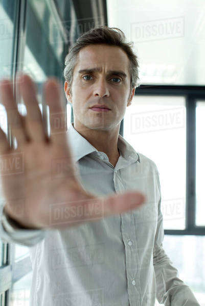 Man holding hand up in front of camera, backlit - Royalty-free Stock ...