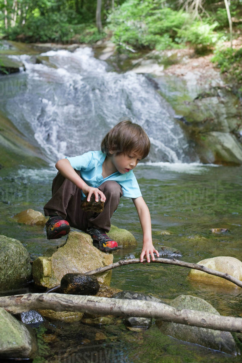 Young boy exploring nature - Stock Photo - Dissolve