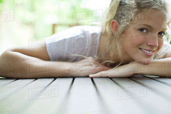 Woman resting head on arms, smiling, portrait - Royalty-free Stock ...