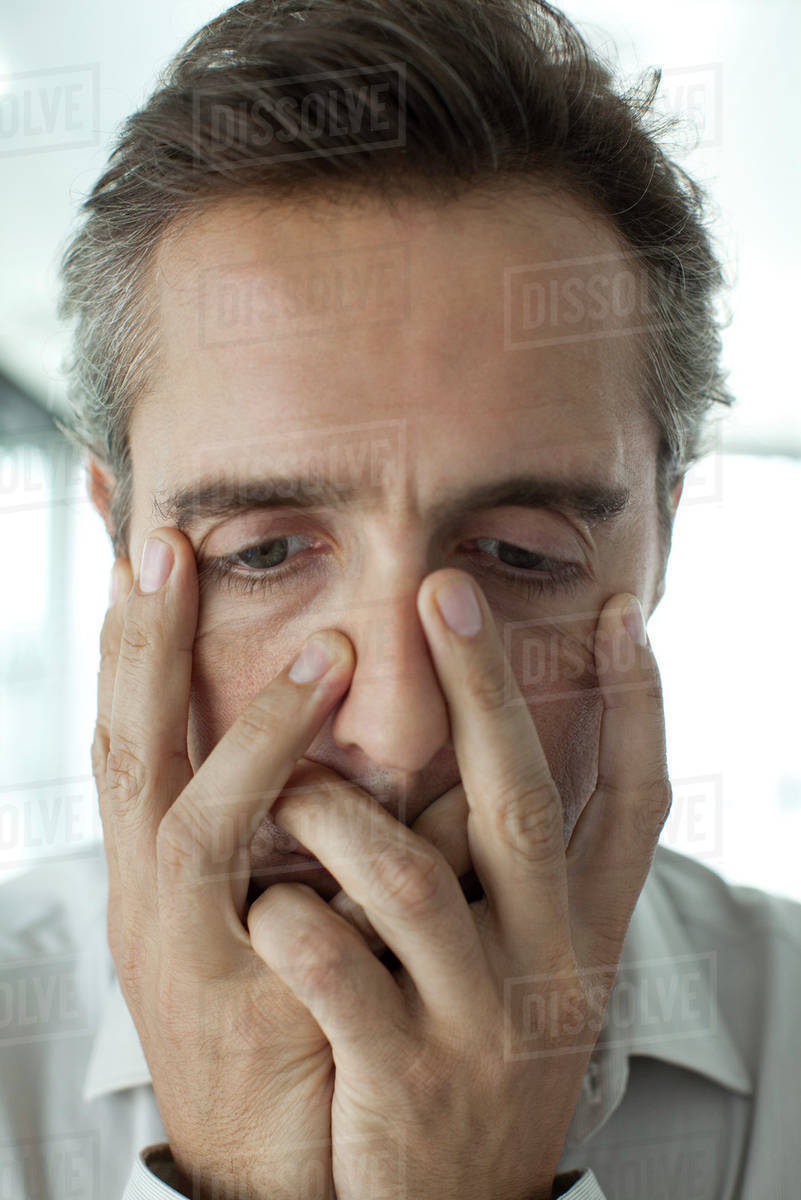 Man with hands covering face - Royalty-free Stock Photo | Dissolve