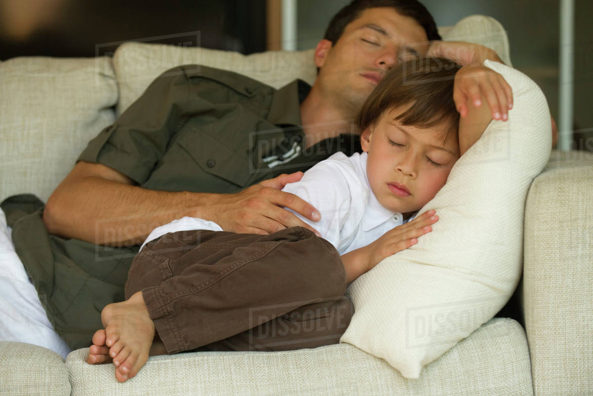 Father and son napping together on sofa - Royalty-free Stock Photo ...