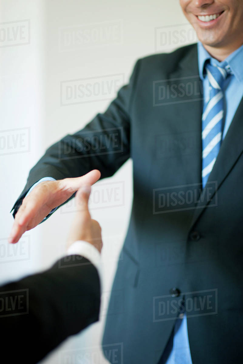 Executives extending hands to shake, cropped - Royalty-free Stock Photo ...