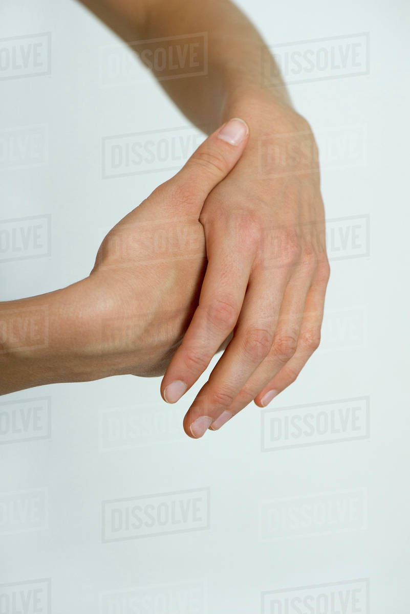 Rubbing hands, cropped - Stock Photo - Dissolve